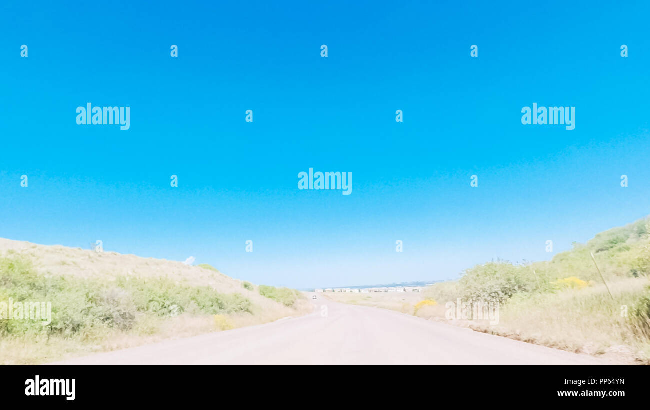 Driving on dirt road through open space in rural suburbia in Colorado ...