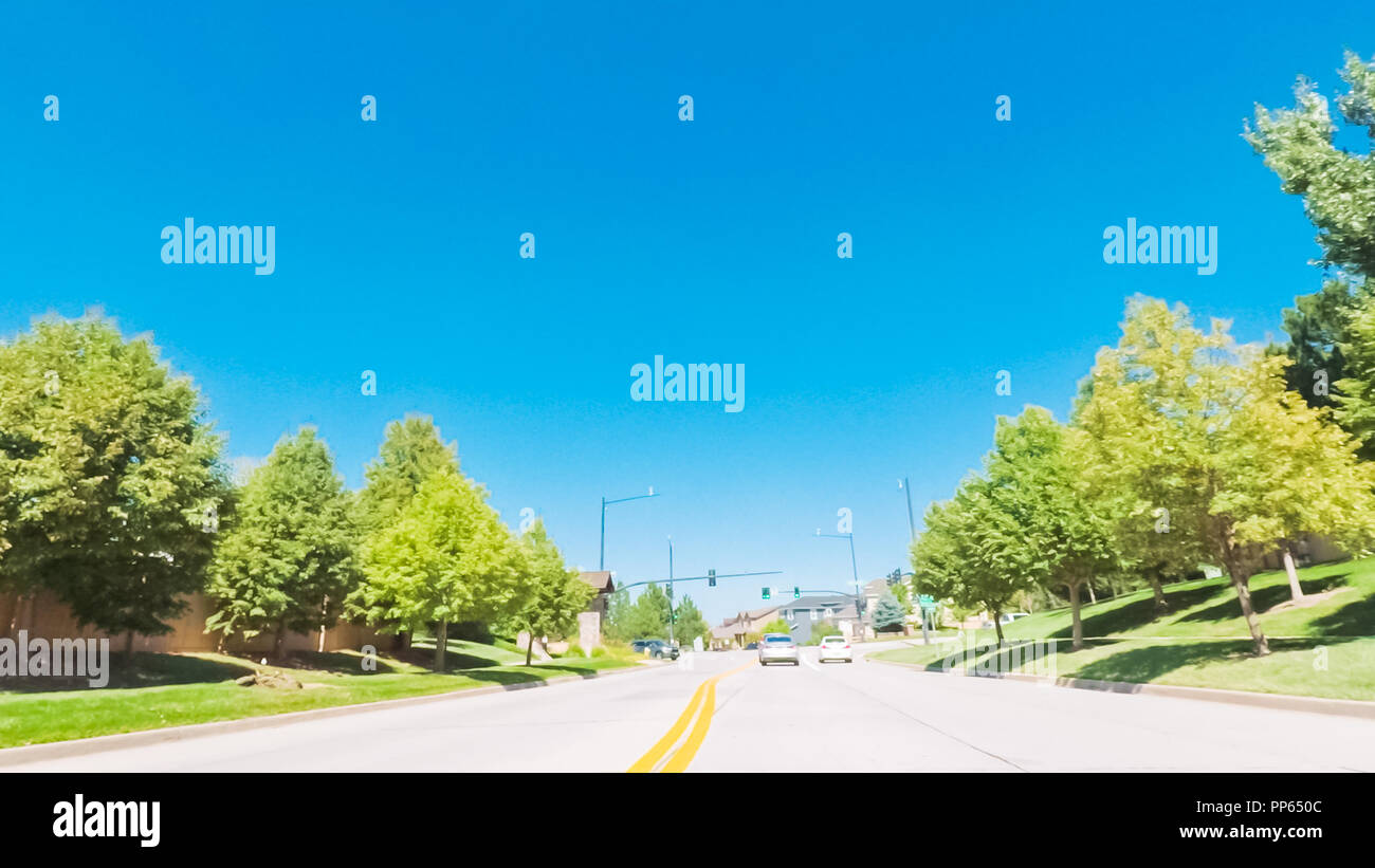 Driving on local road through suburbia in South Denver, Colorado Stock ...