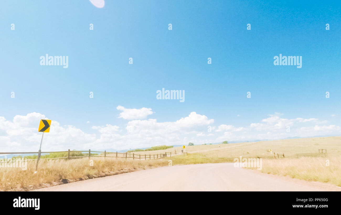 Driving on dirt road through open space in rural suburbia in Colorado ...