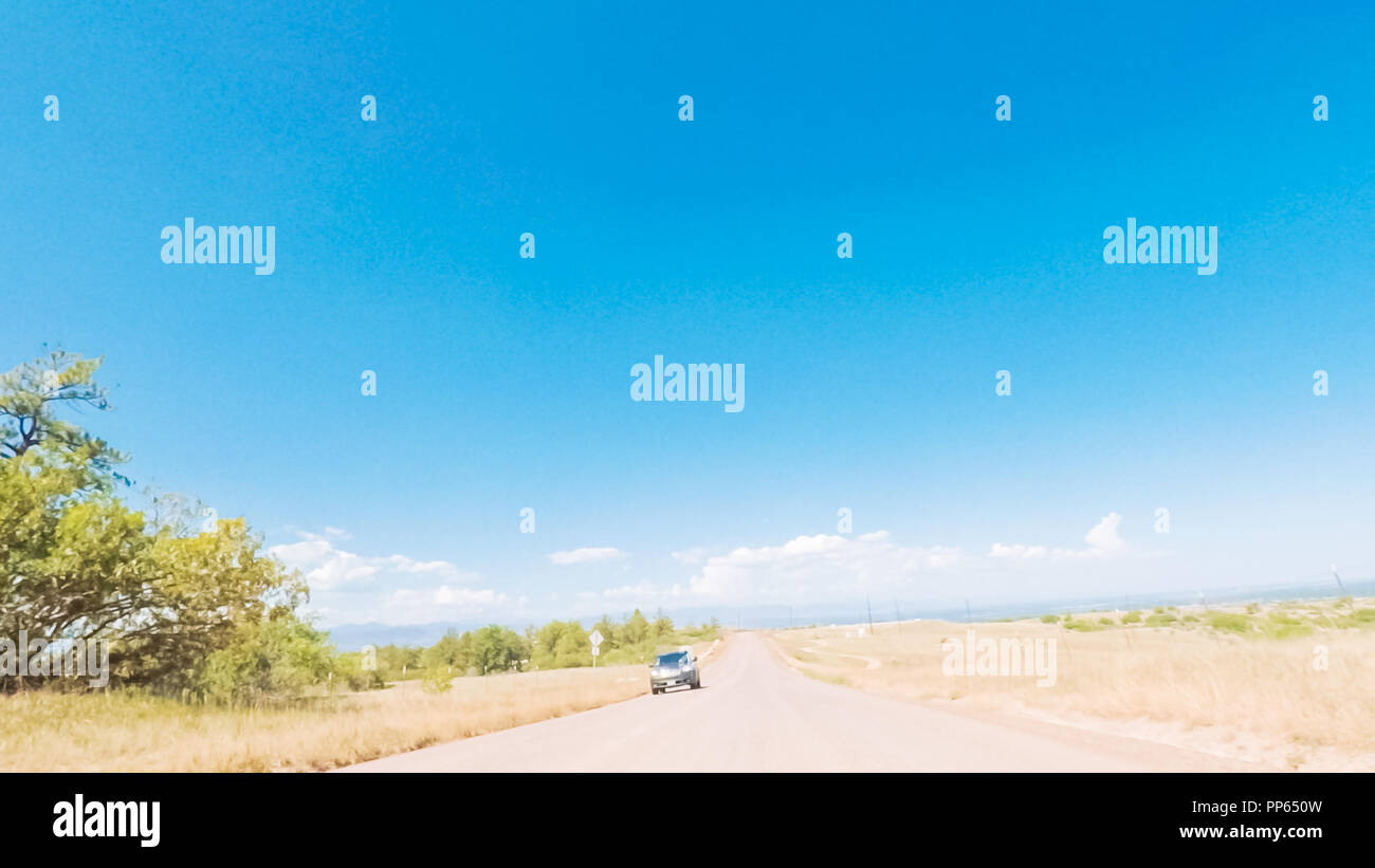 Driving on dirt road through open space in rural suburbia in Colorado ...
