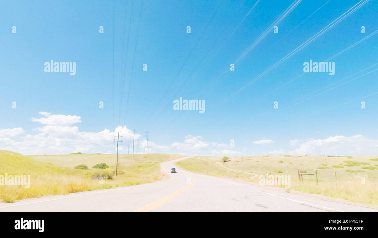 Driving on dirt road through open space in rural suburbia in Colorado ...