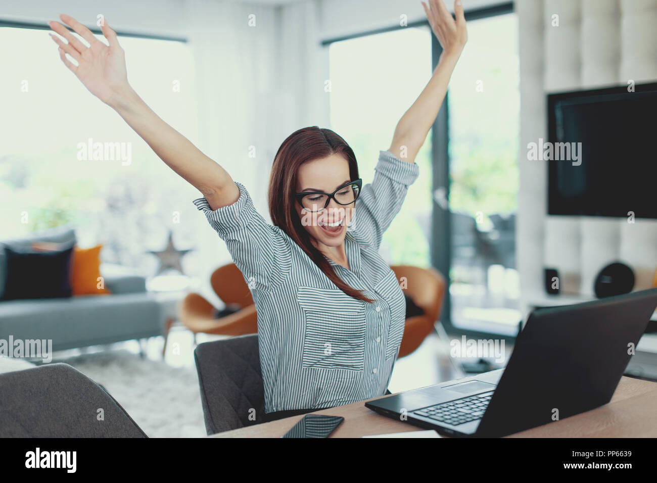 Happy modern nerd woman win at laptop indoors, success and happiness ...