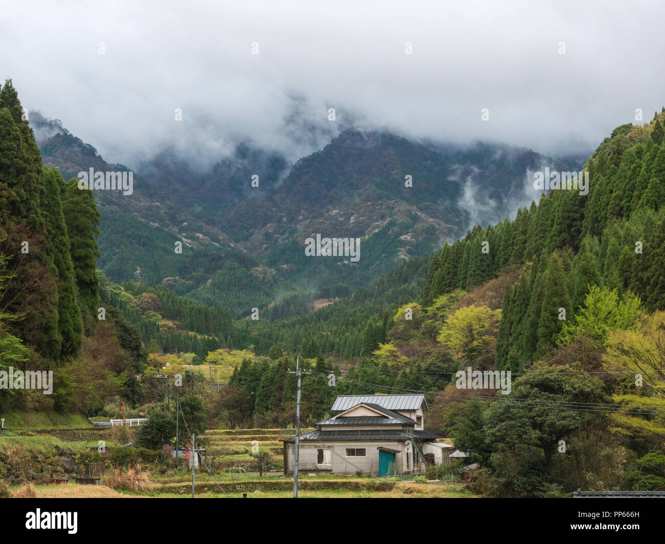 Farm house in mountain valley, clouds and forest, Kobaru, Kyushu, Japan ...
