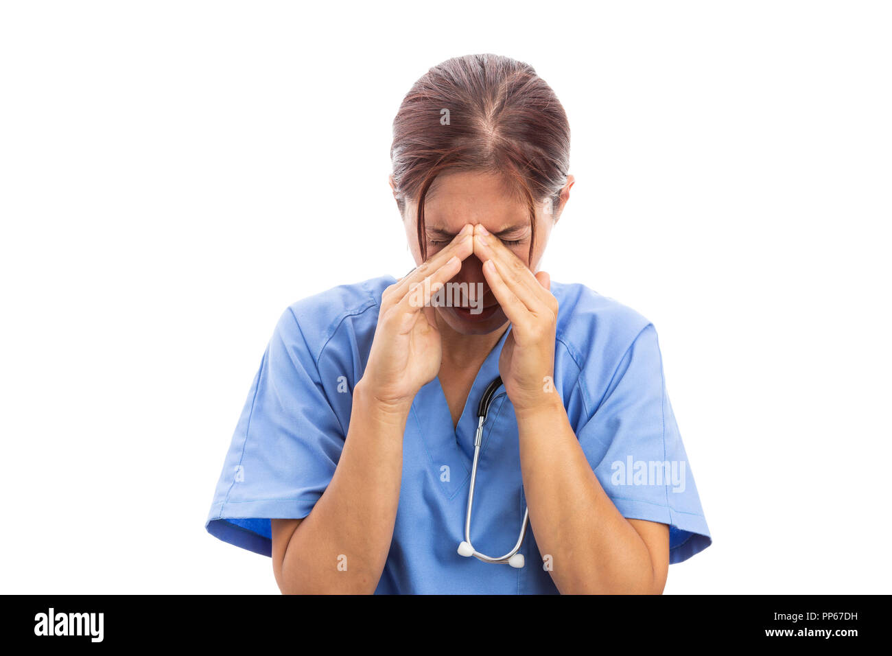 Woman nurse holding head sinuses with hands suffering from cold or flu ...