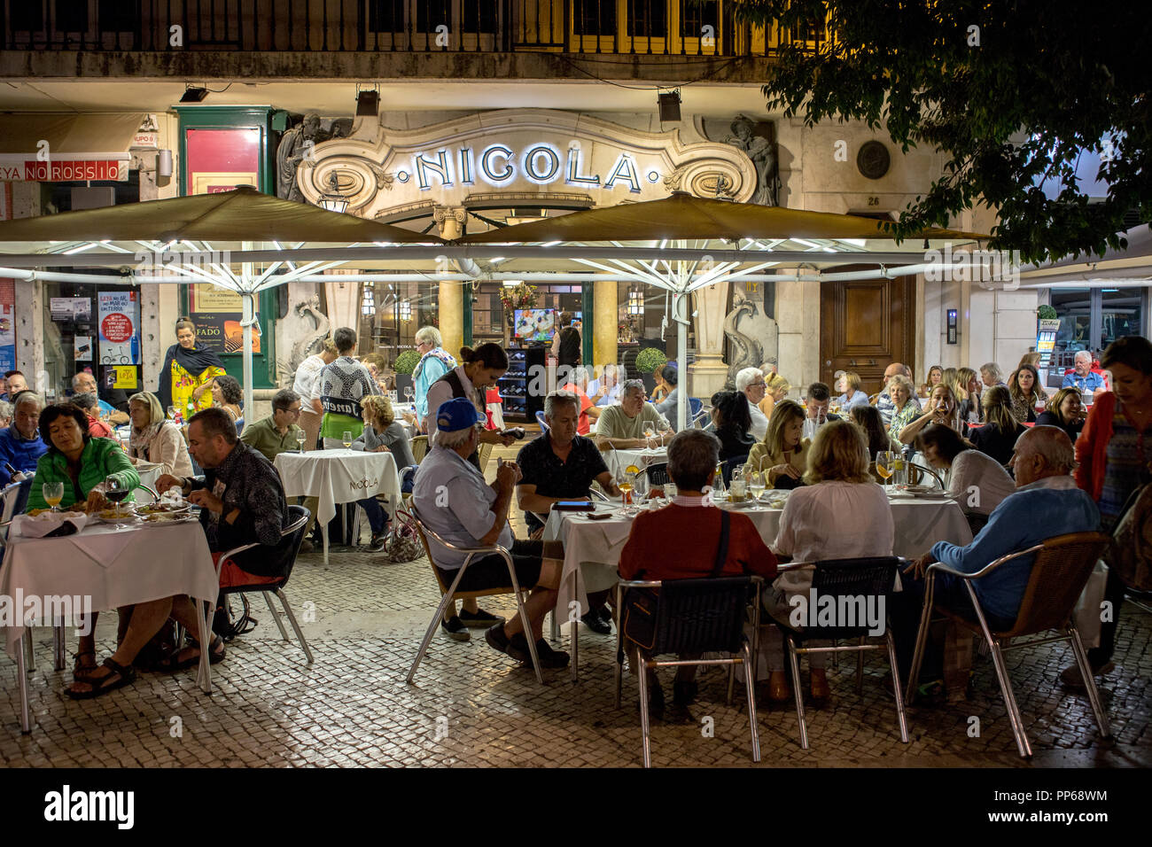 Lisbon bar restaurant on street, people in night life. Portugal Stock ...