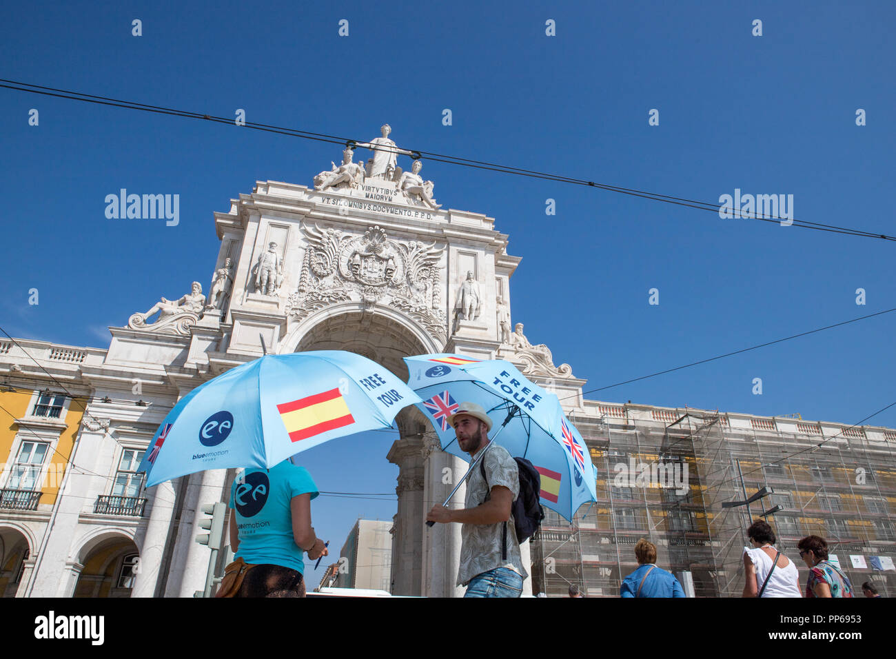 Touristic guides in front of Triumphal Arch, Praca do Comercio or Terreiro do Paco square in ...
