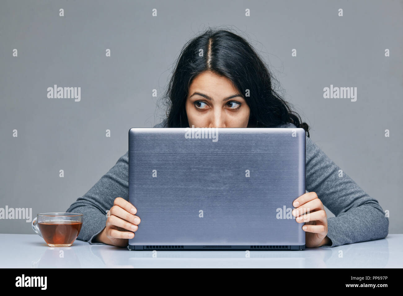 young woman with a computer. She does not know what to do next Stock ...