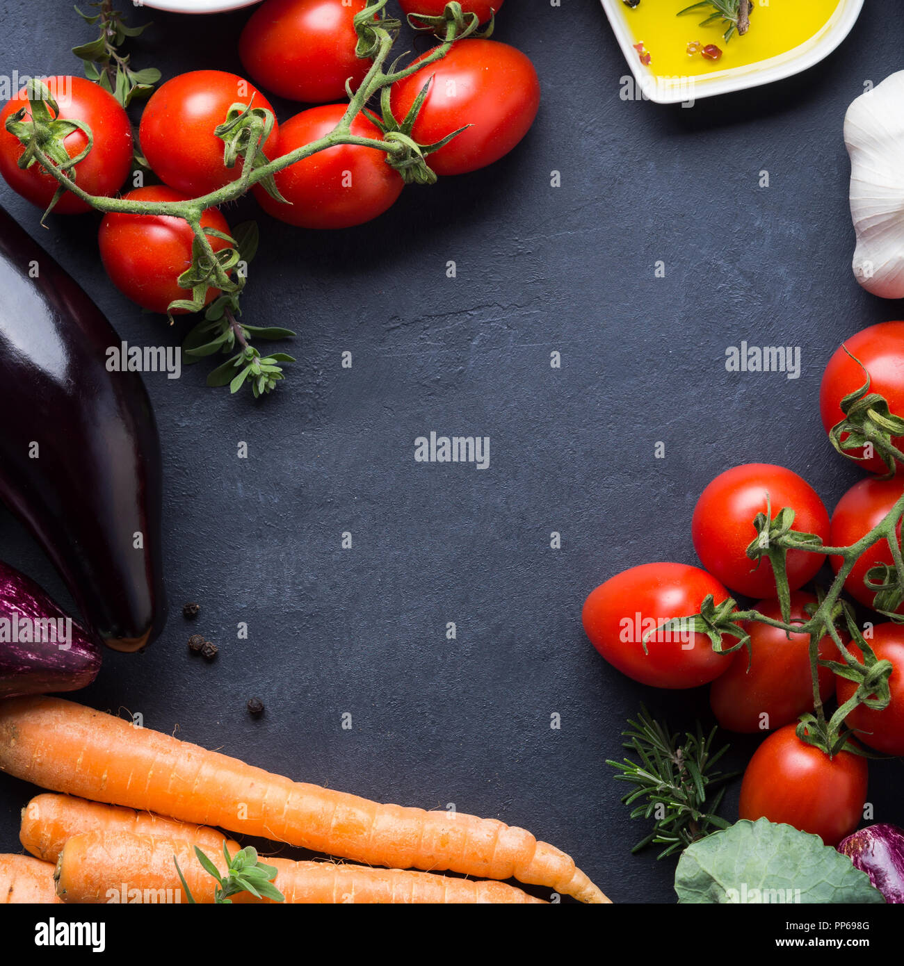 Mix of raw vegetables with salt, spices on dark background. Clean ...