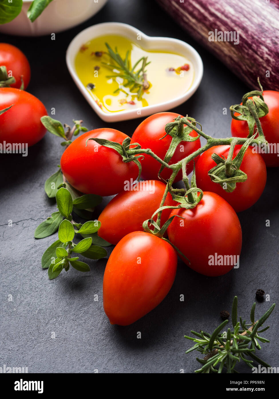 Mix of raw vegetables with salt, spices on dark background. Clean ...