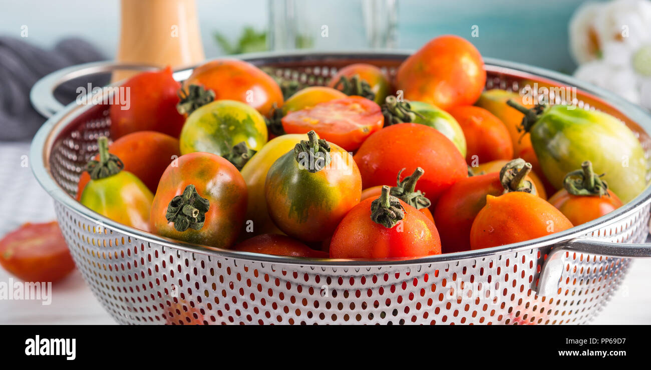 Italian tomatoes in a colander on table. Cooking with tomatoes concept ...
