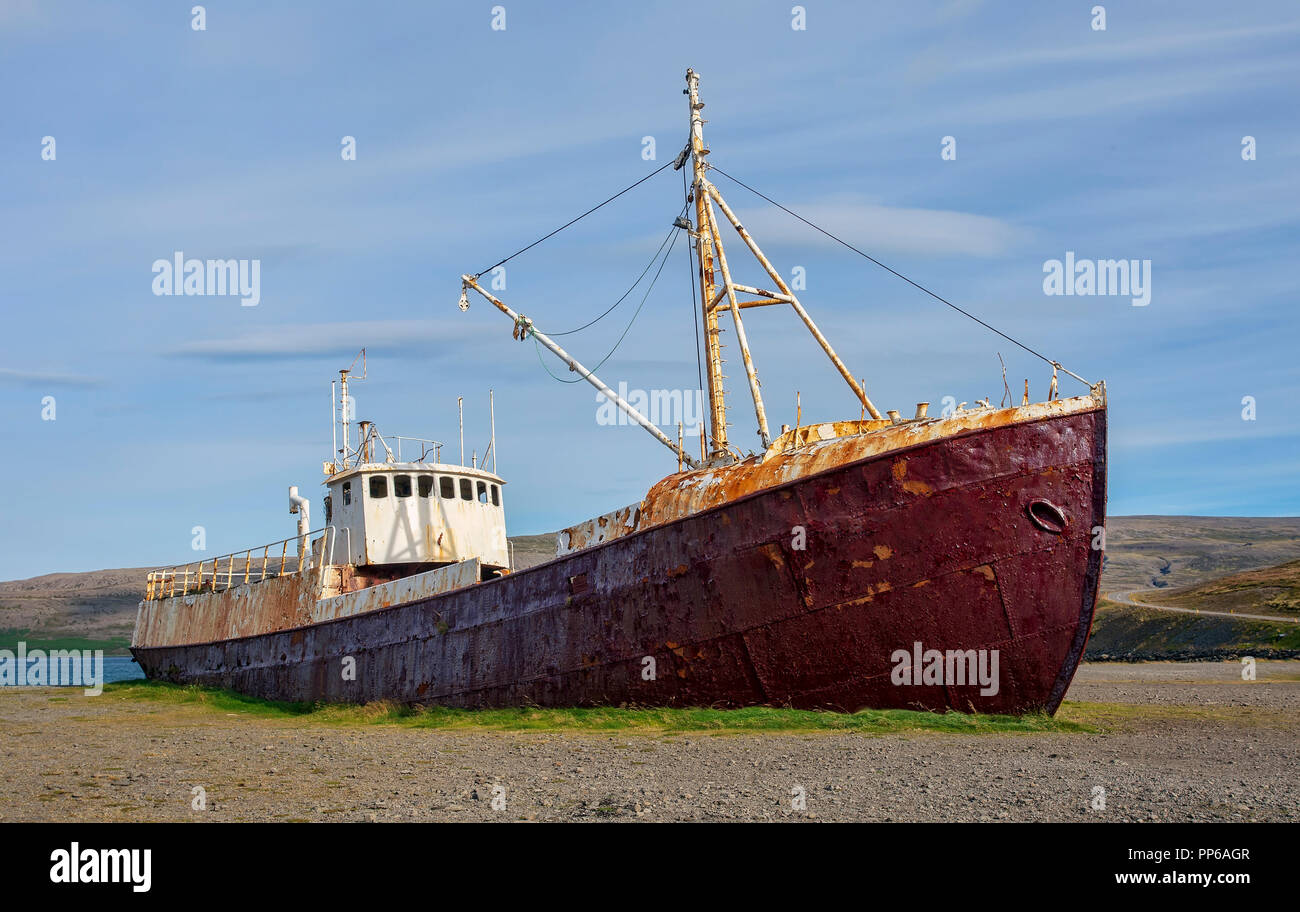 An old rusted steel shipwreck sits on an Icelandic beach Stock Photo ...