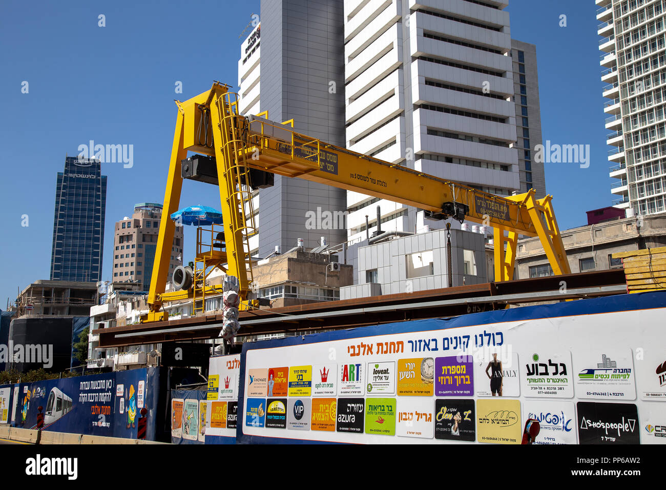 Yellow overhead crane at subway construction site in Tel Aviv, Israel ...