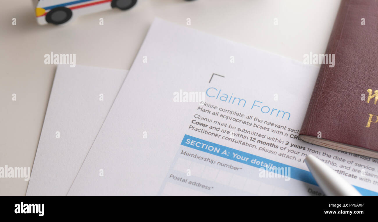 Insurance claim concept with pen and brown passport Stock Photo - Alamy