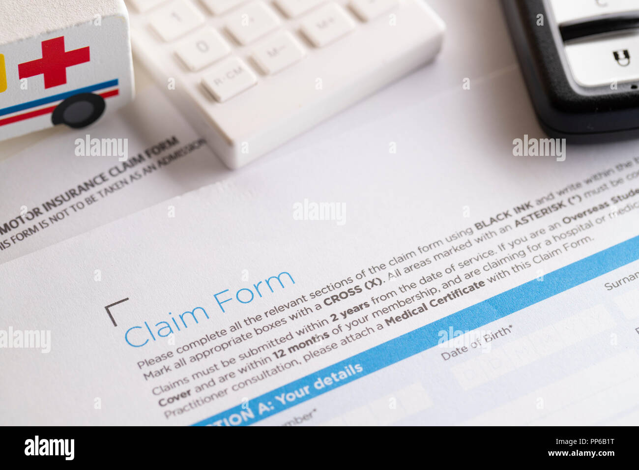 paper claim form with car model and car remote lay on table Stock Photo ...