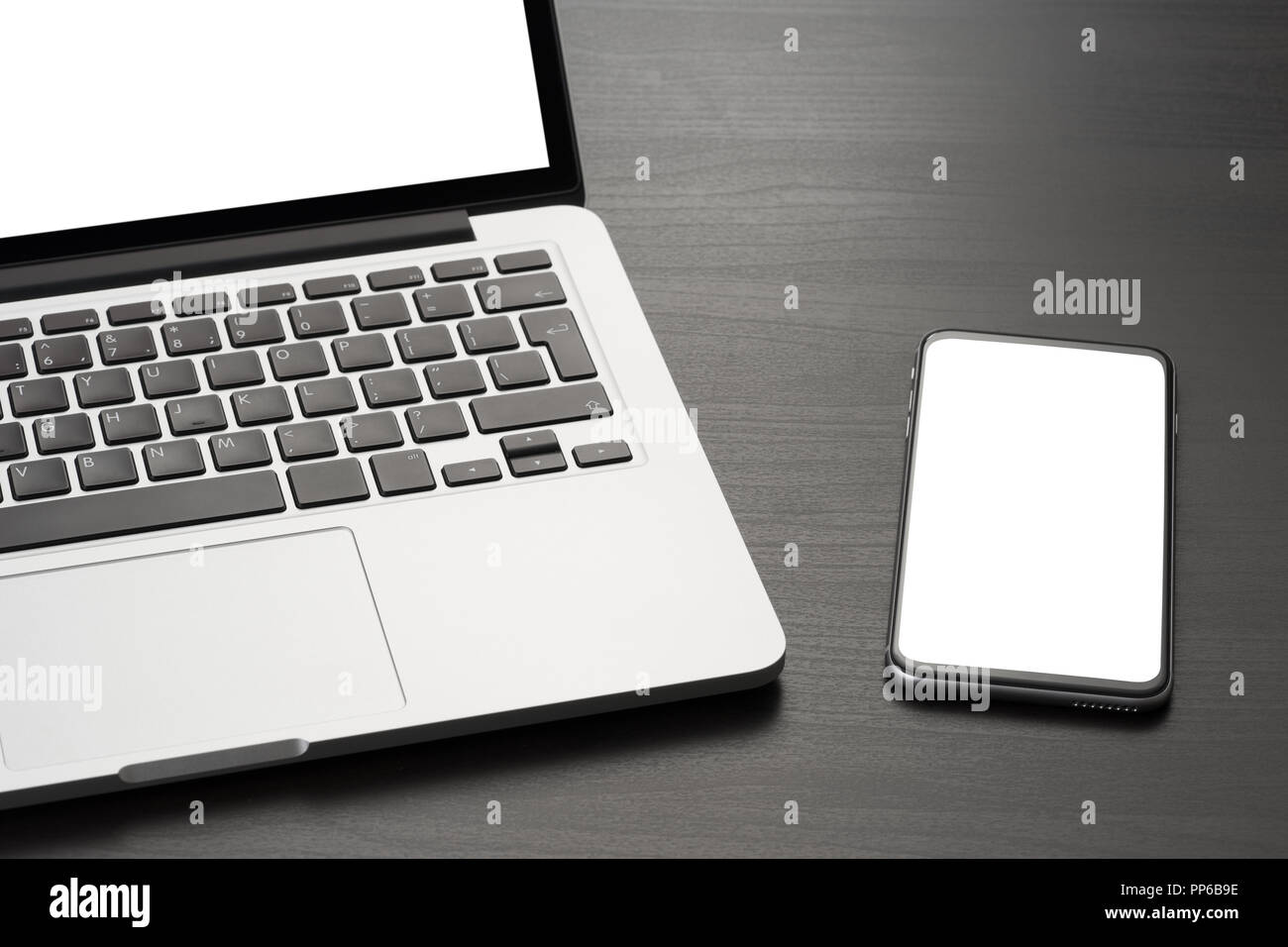 Smartphone and laptop on the table, isolated Stock Photo - Alamy