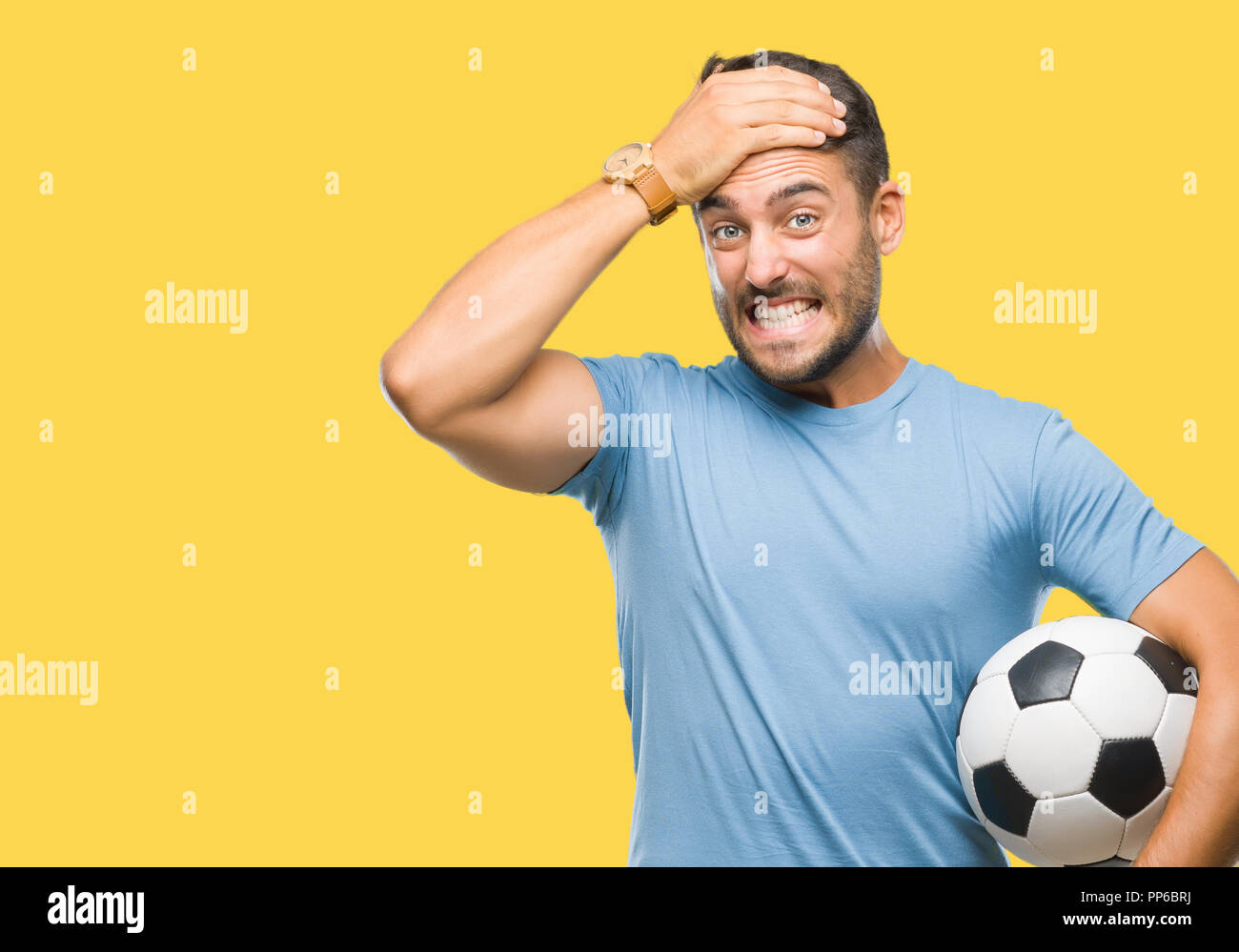 Young handsome man holding soccer football ball over isolated ...