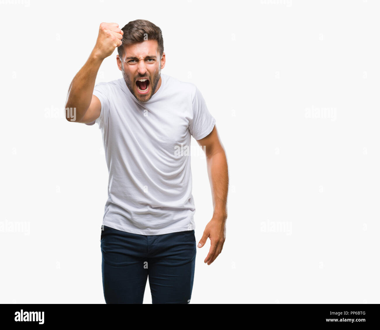 Young handsome man over isolated background angry and mad raising fist ...