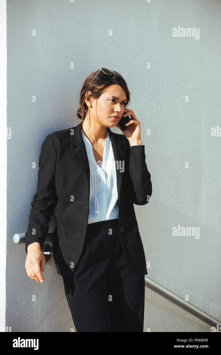 Beautiful businesswoman walking outdoors - Pretty young adult female ...