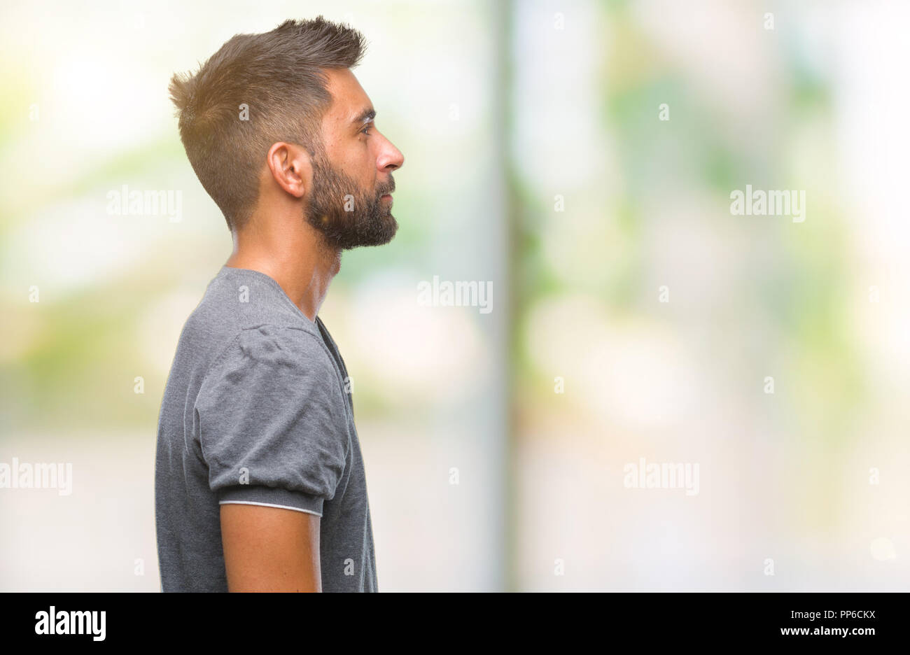Adult hispanic man over isolated background looking to side, relax ...