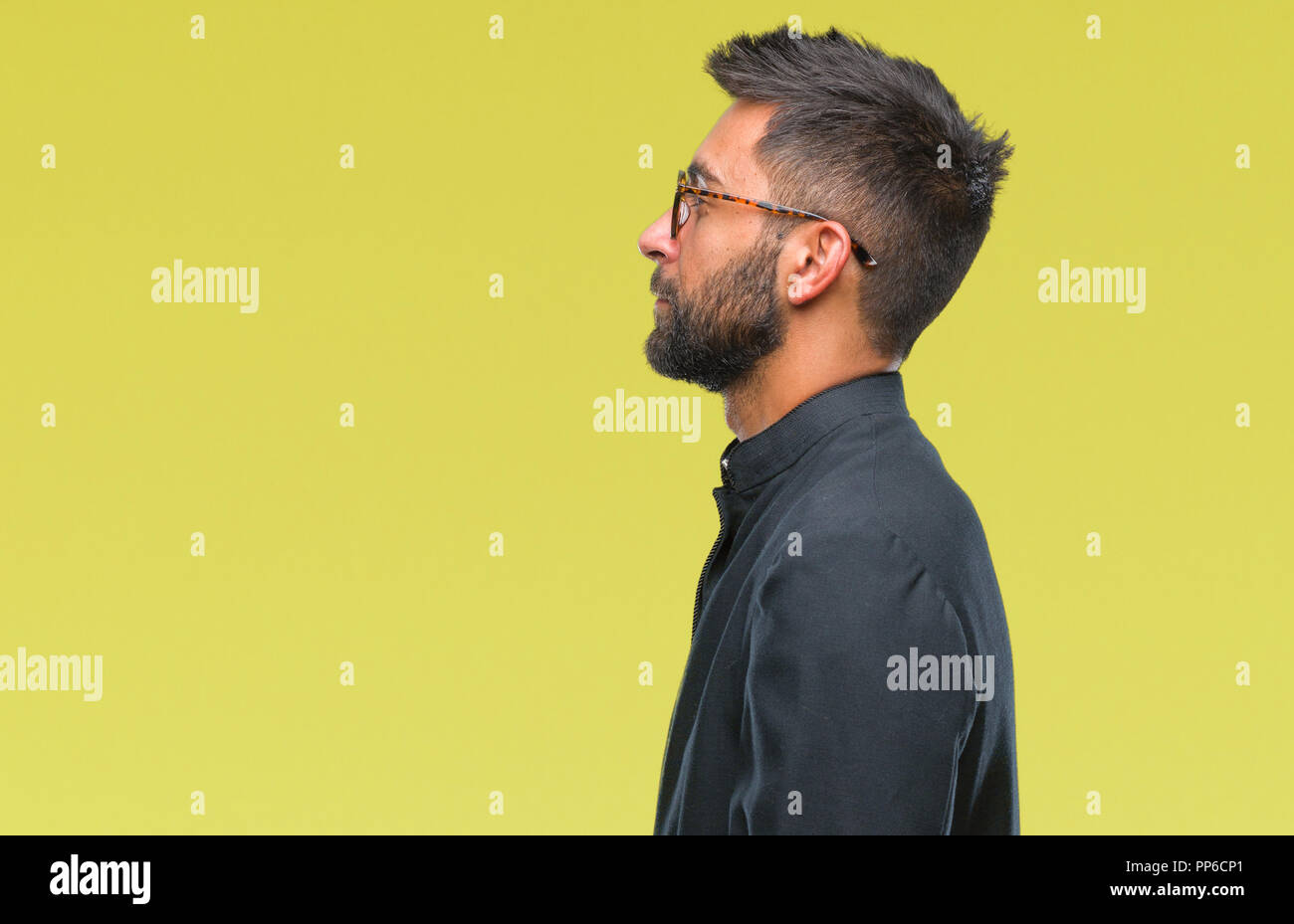 Adult hispanic catholic priest man over isolated background looking to ...