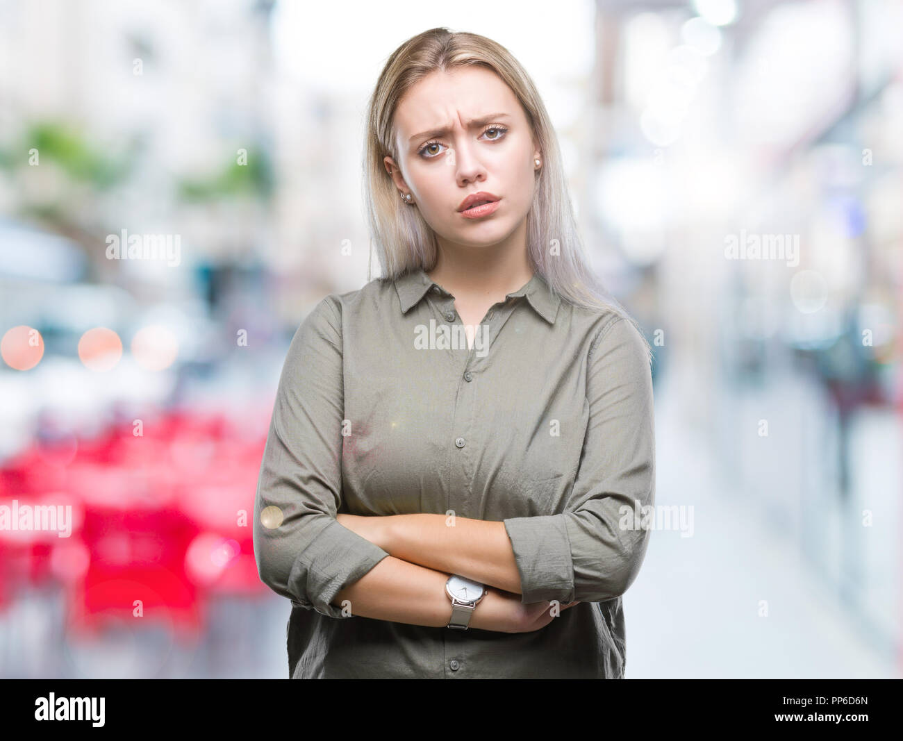 Young blonde business woman over isolated background skeptic and ...