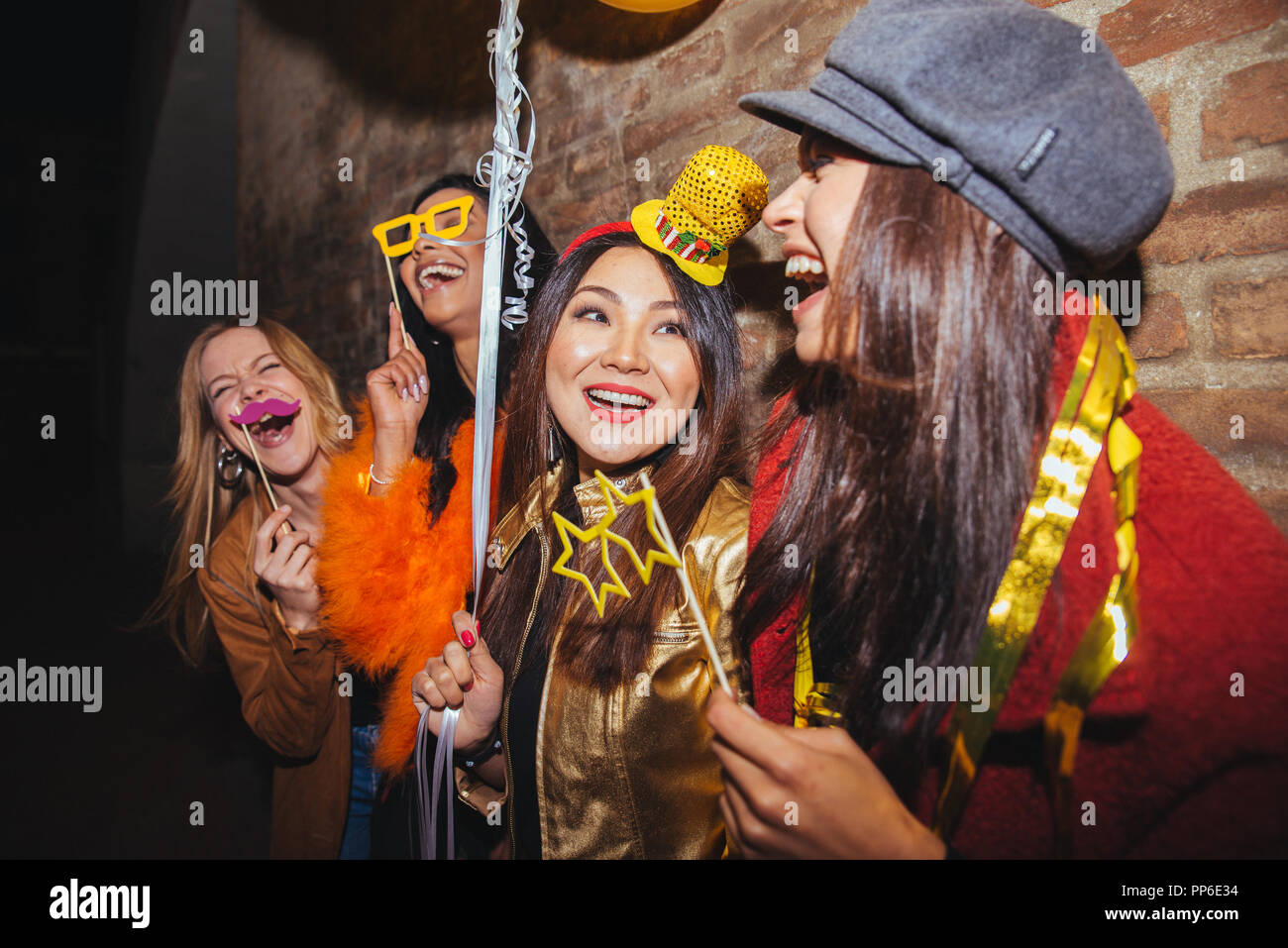 Group of happy girls having party in a club - Four young women having a ...