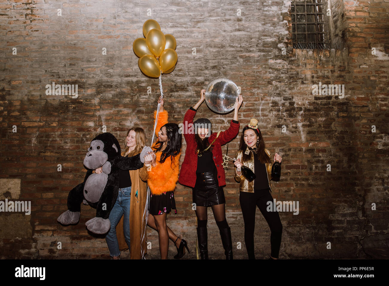 Group of happy girls having party in a club - Four young women having a ...