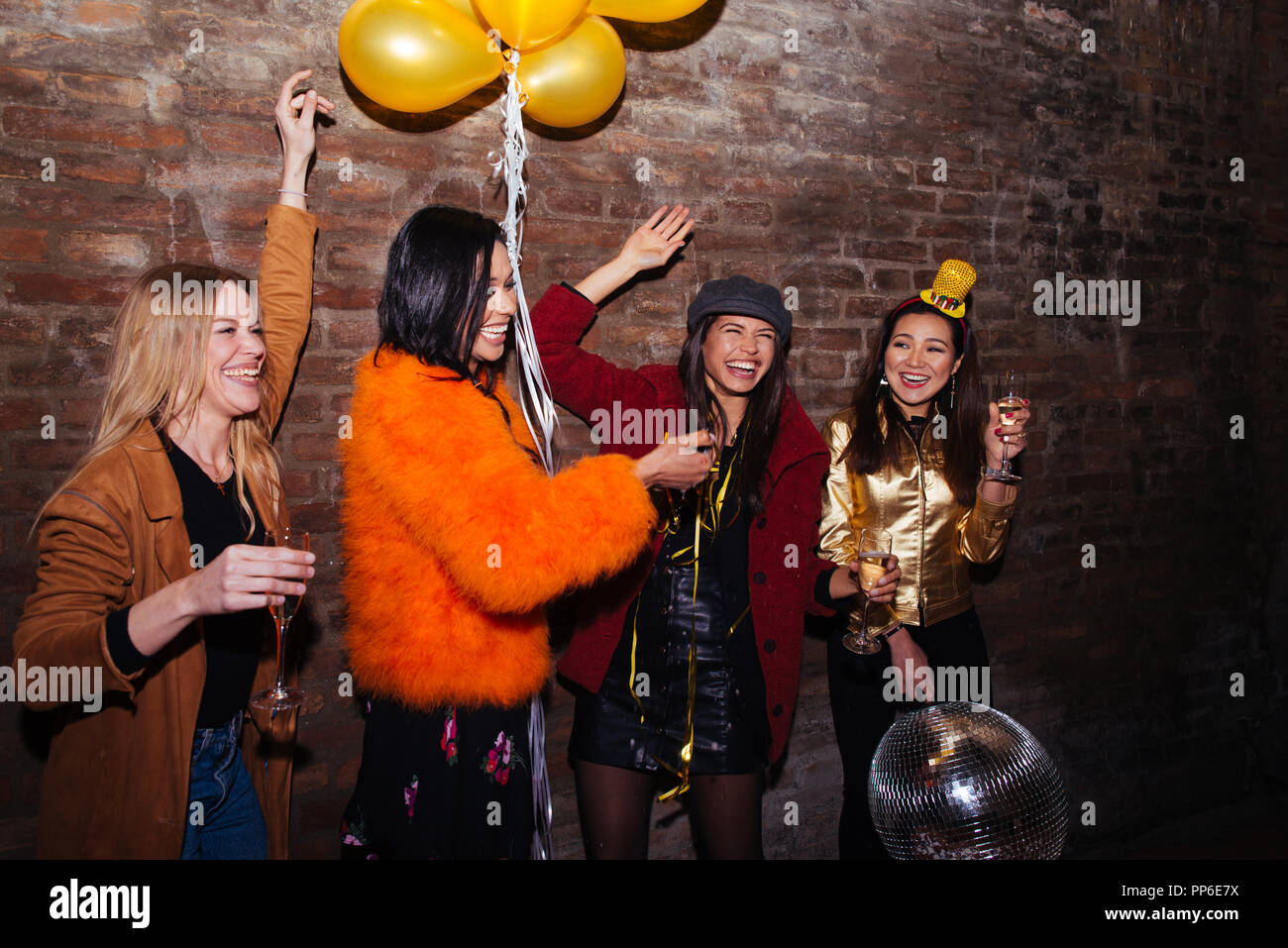 Group of happy girls having party in a club - Four young women having a ...