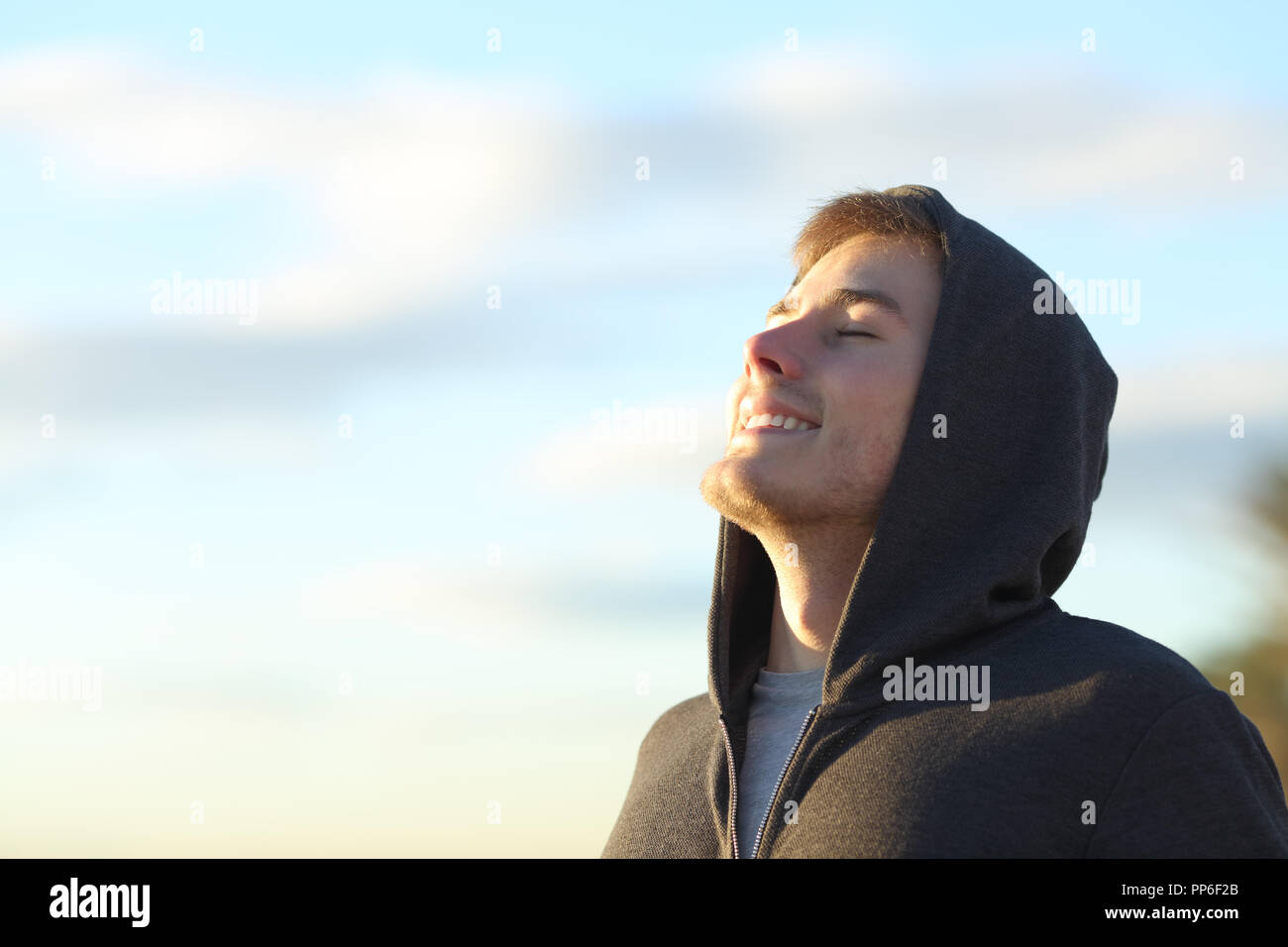 Portrait of a teenage boy breathing deep fresh air Stock Photo - Alamy
