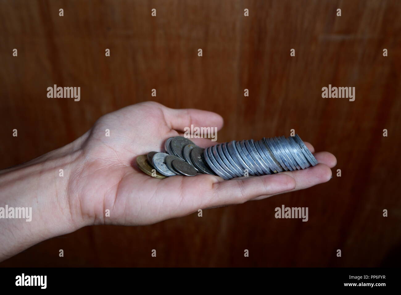 Handful of coins in palm. Concept of saving and passive income Stock ...