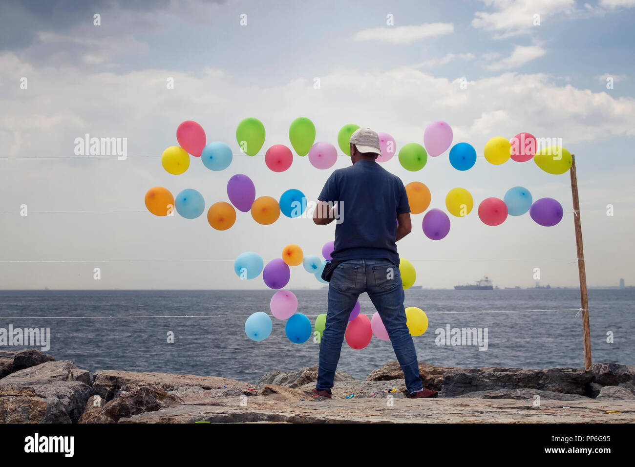 Standing man with balloons hi-res stock photography and images - Alamy
