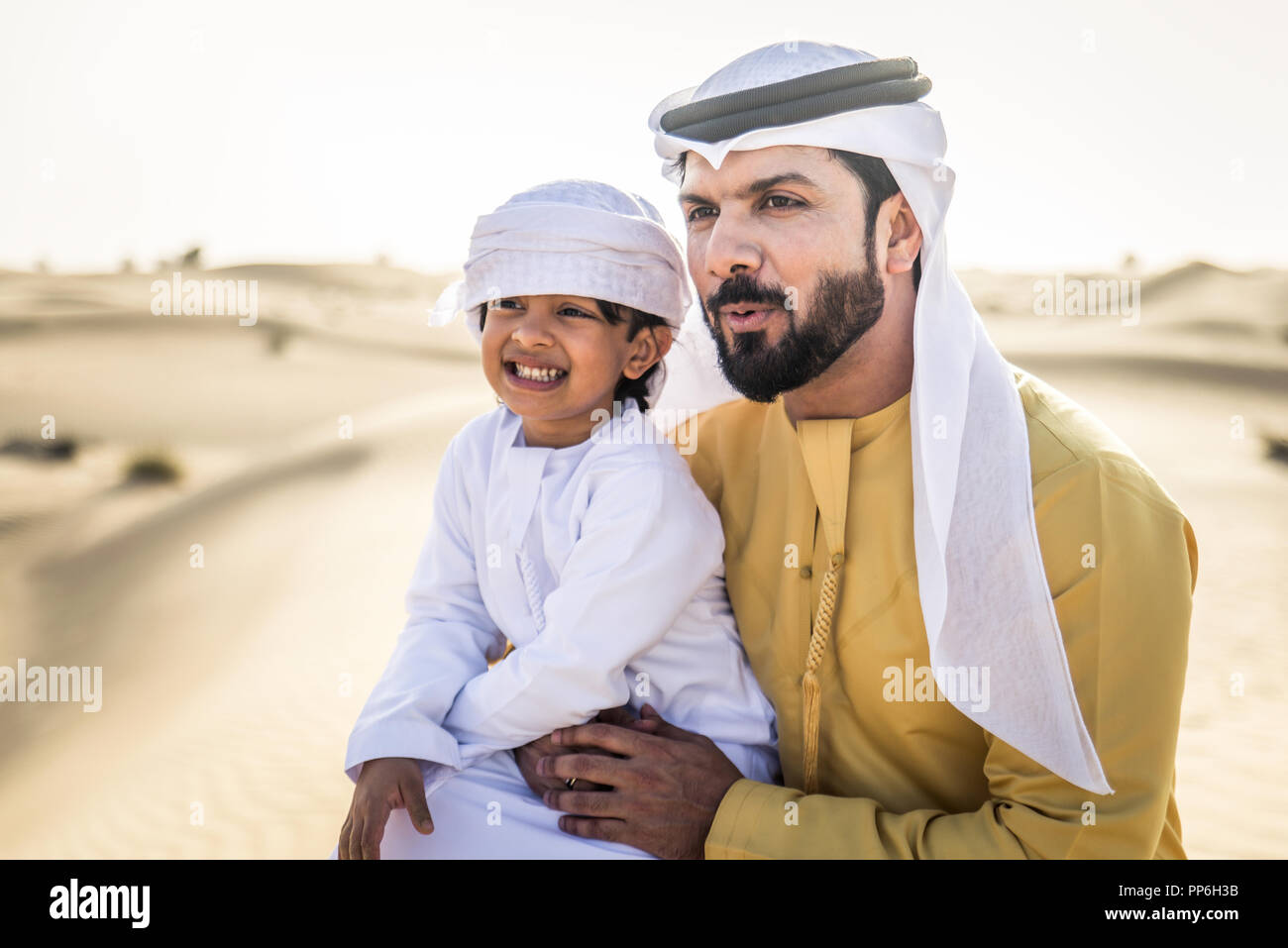 Happy family playing in the desert of Dubai - Playful father and his ...