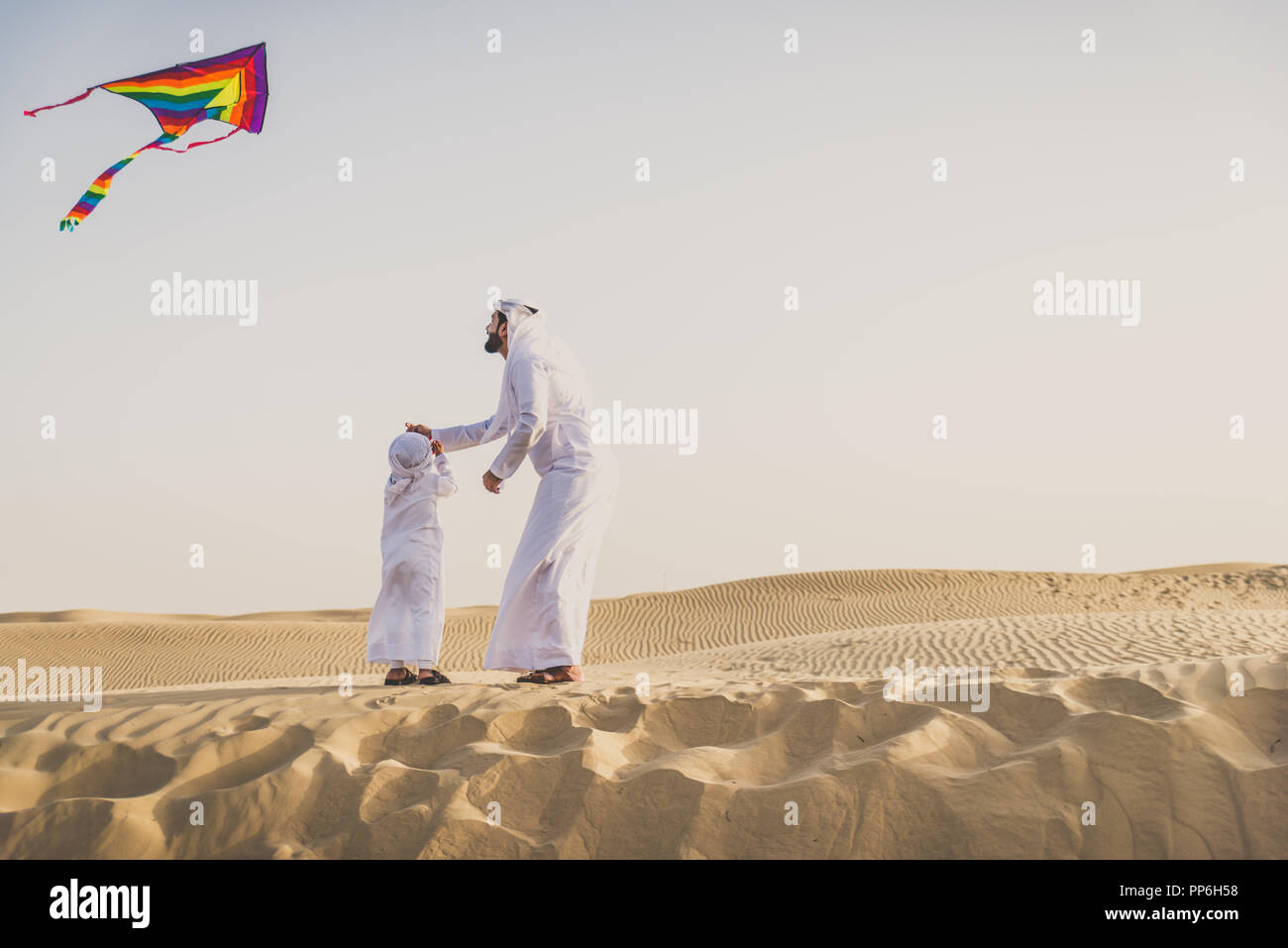Happy family playing in the desert of Dubai - Playful father and his ...