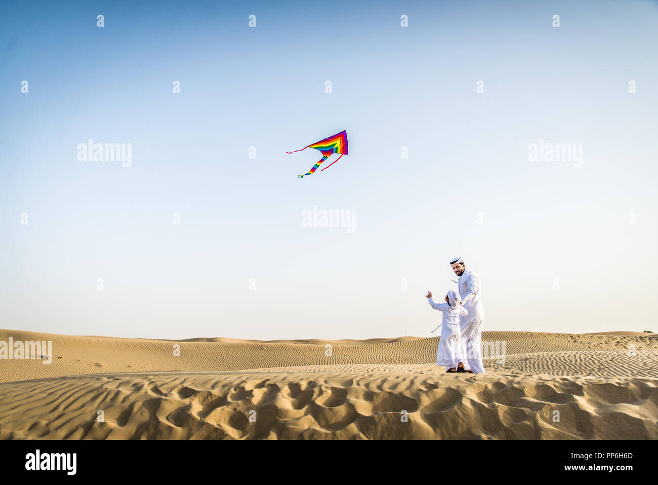 Happy family playing in the desert of Dubai - Playful father and his ...