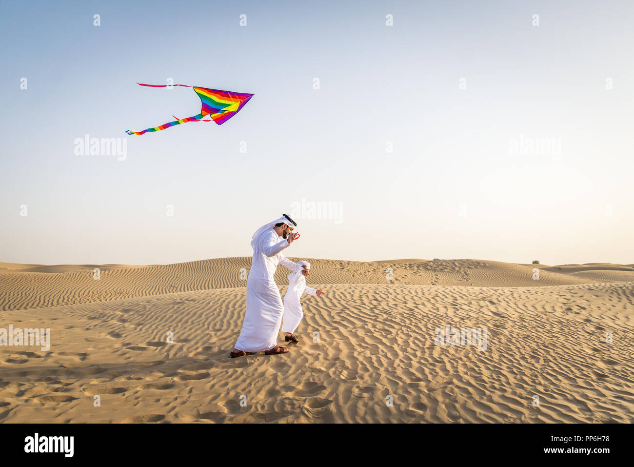 Happy family playing in the desert of Dubai - Playful father and his ...