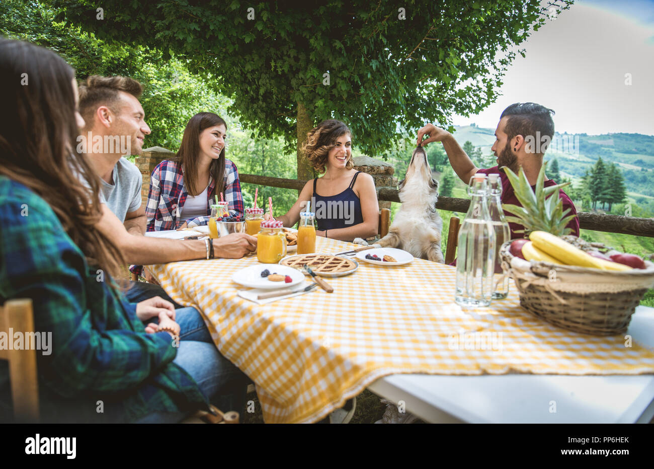 Group of happy people doing breakfast outdoors in a traditional ...