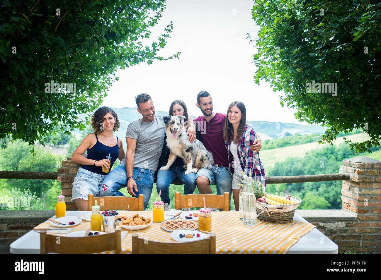 Group of happy people doing breakfast outdoors in a traditional ...