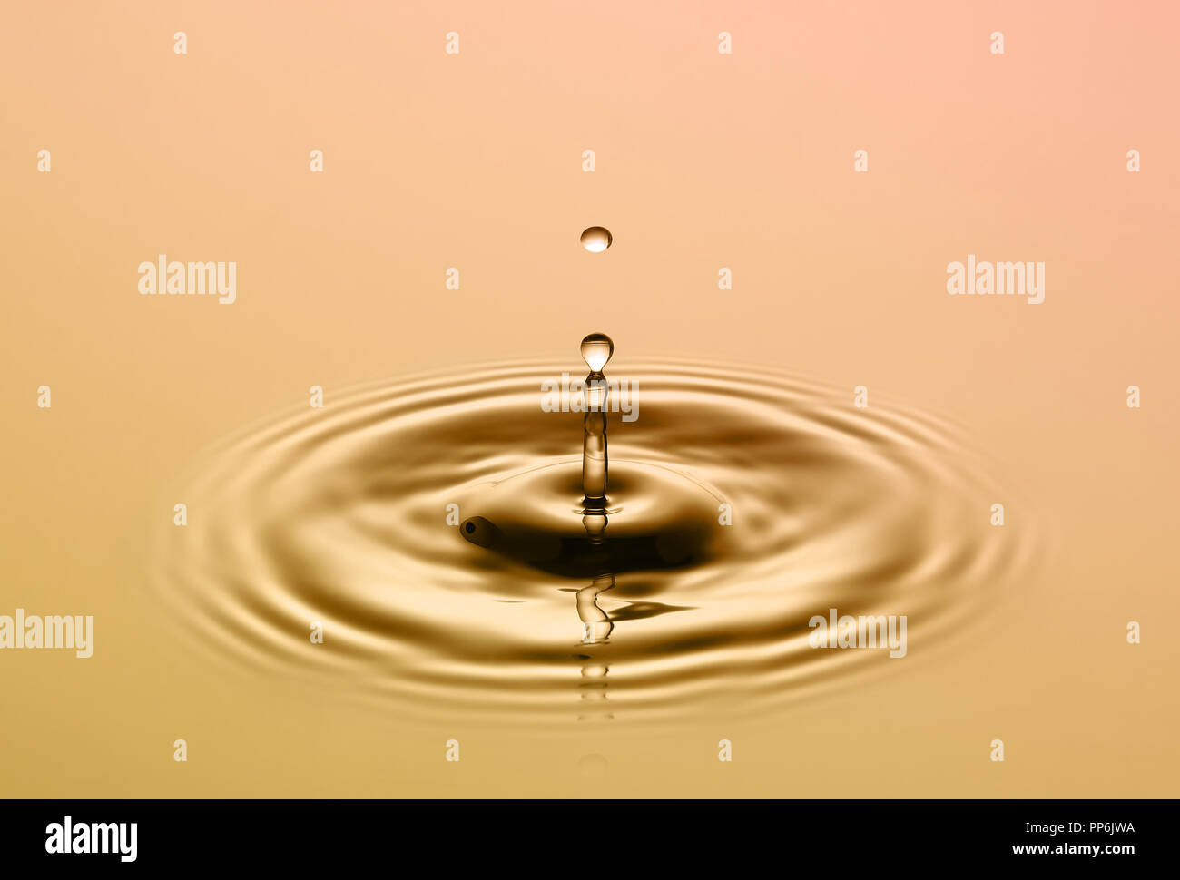 Drop falling on smooth surface of water Stock Photo - Alamy