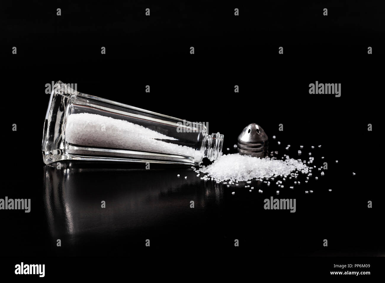 White Salt Pile With Shaker on Black Background with reflection Stock ...
