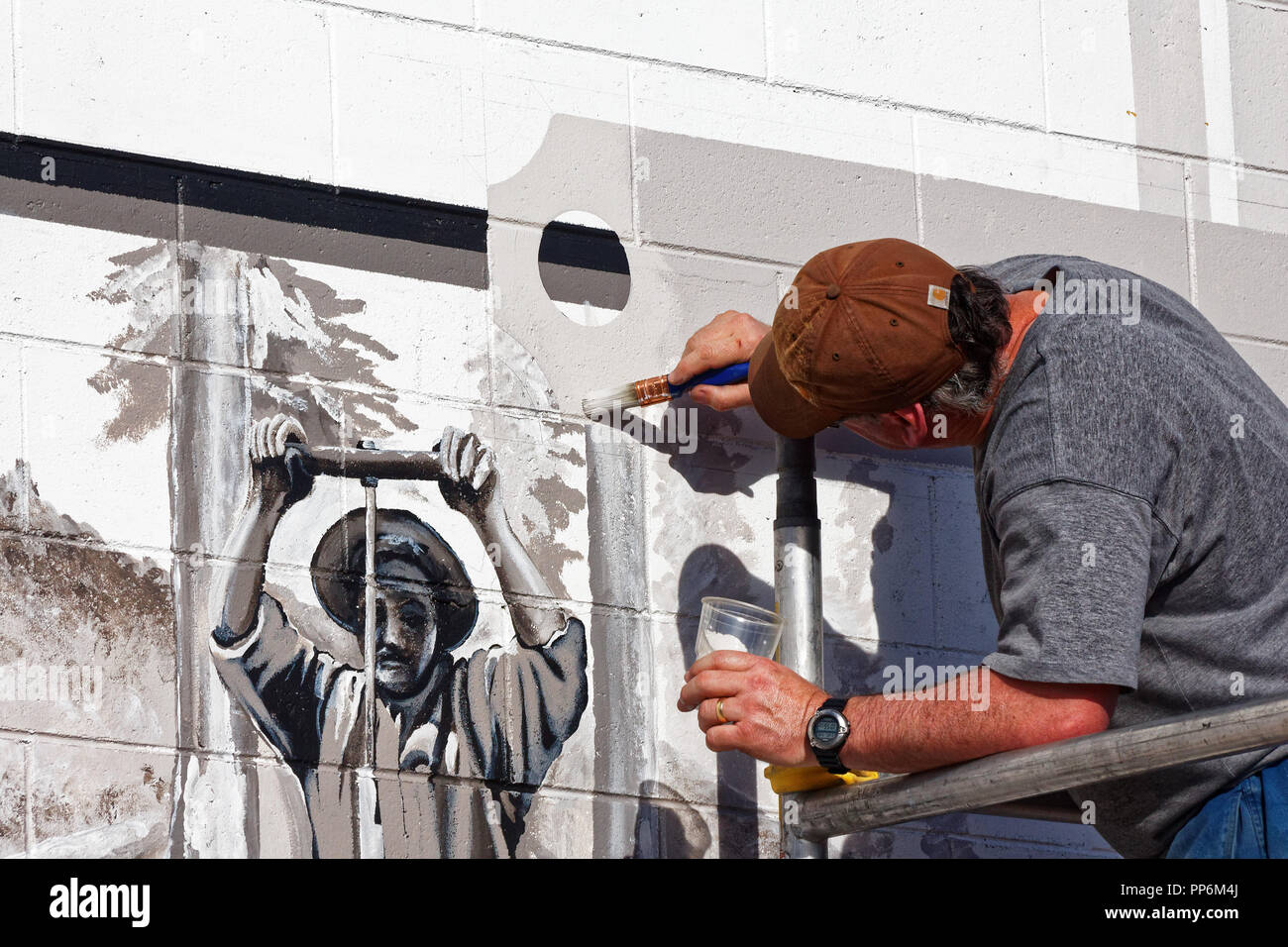 Man painting a mural Stock Photo - Alamy
