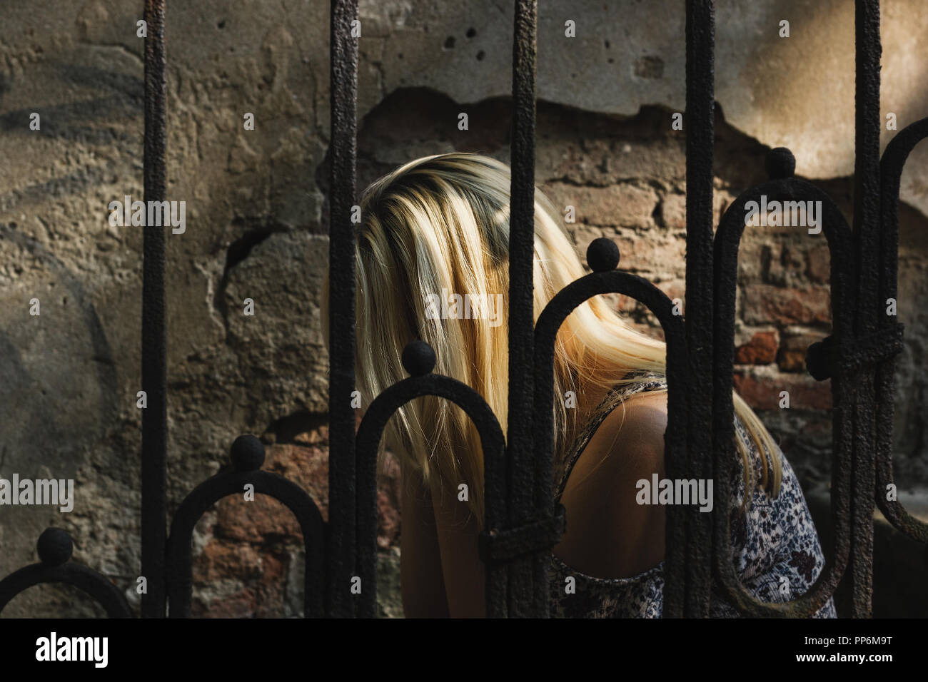Old woman hiding behind fence hi-res stock photography and images - Alamy