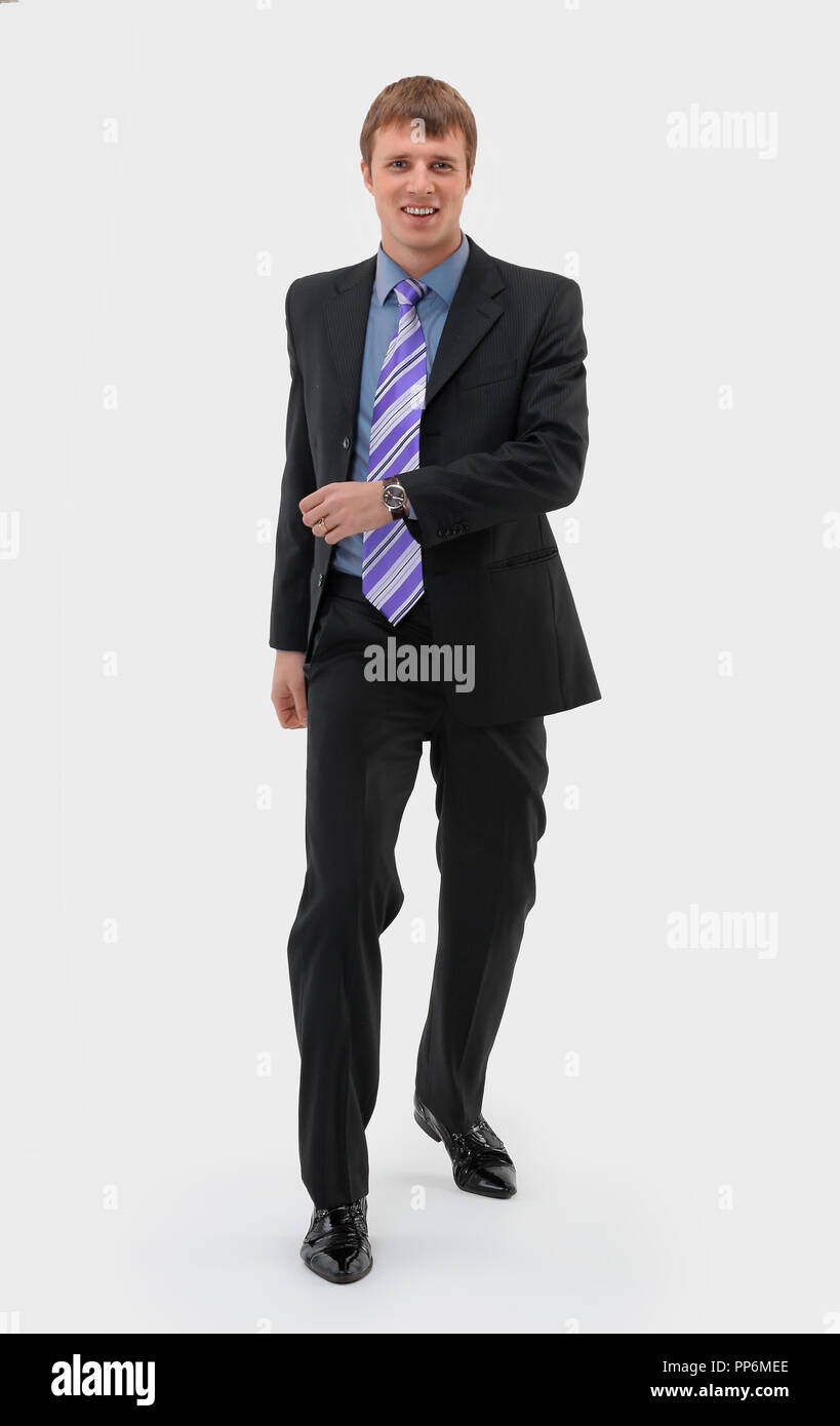 Happy business man walking on white studio background Stock Photo - Alamy