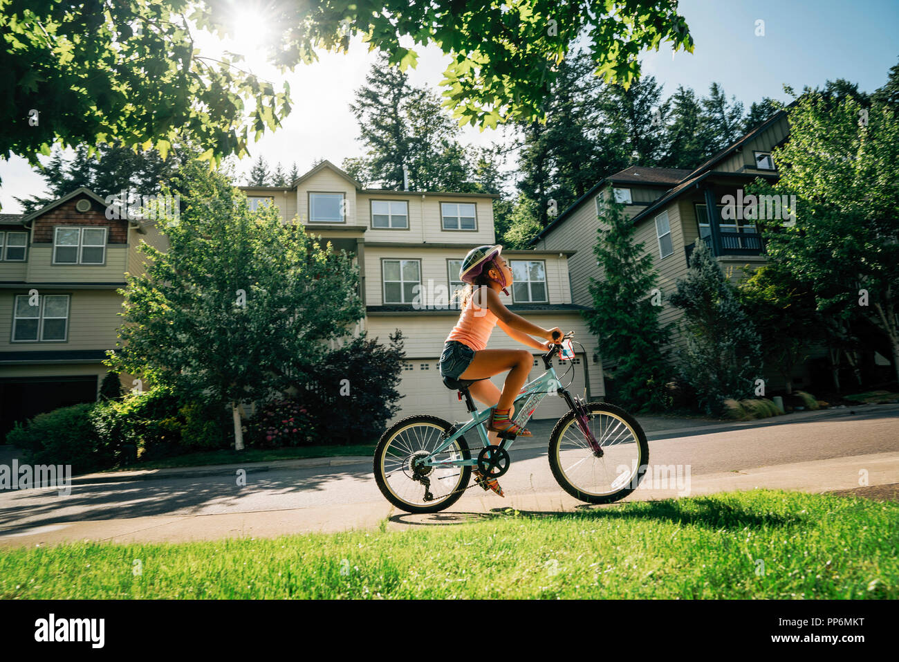 Tween Girl Biking on Sidewalk in Residential Neighborhood Stock Photo ...
