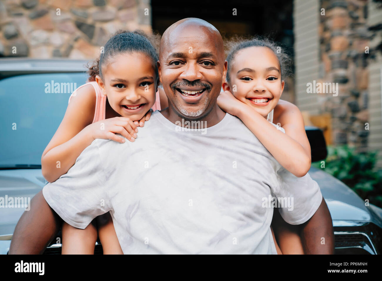 Father hugging daughters hi-res stock photography and images - Alamy