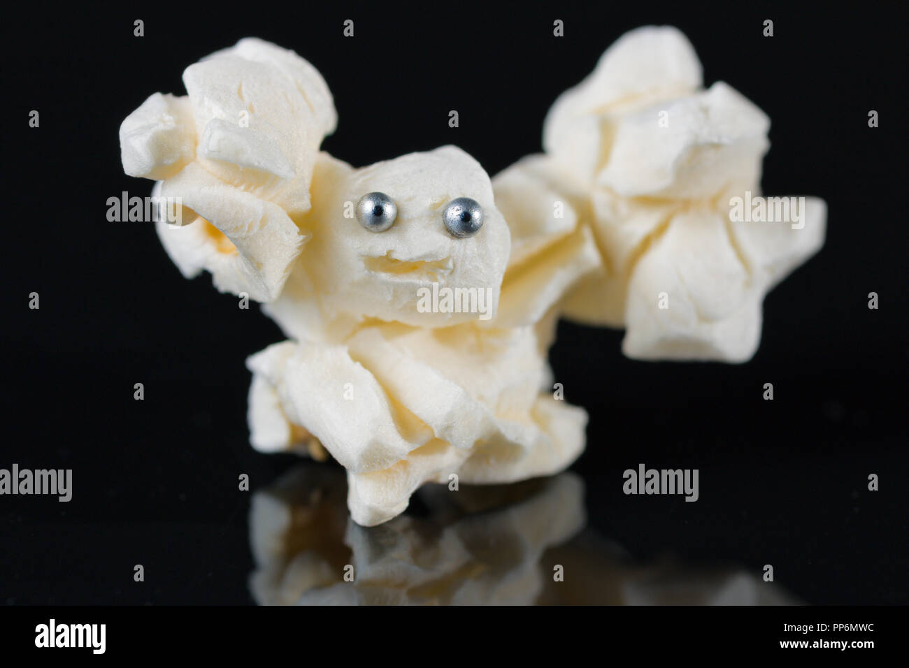 Fun popcorn buddha boxer with pinhead for eyes on black background ...