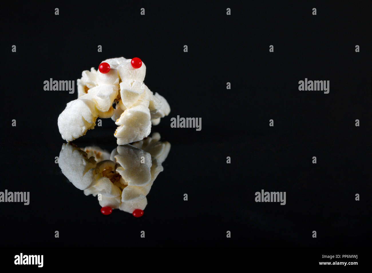 Fun Halloween popcorn animal crab with pinhead for eyes on black ...