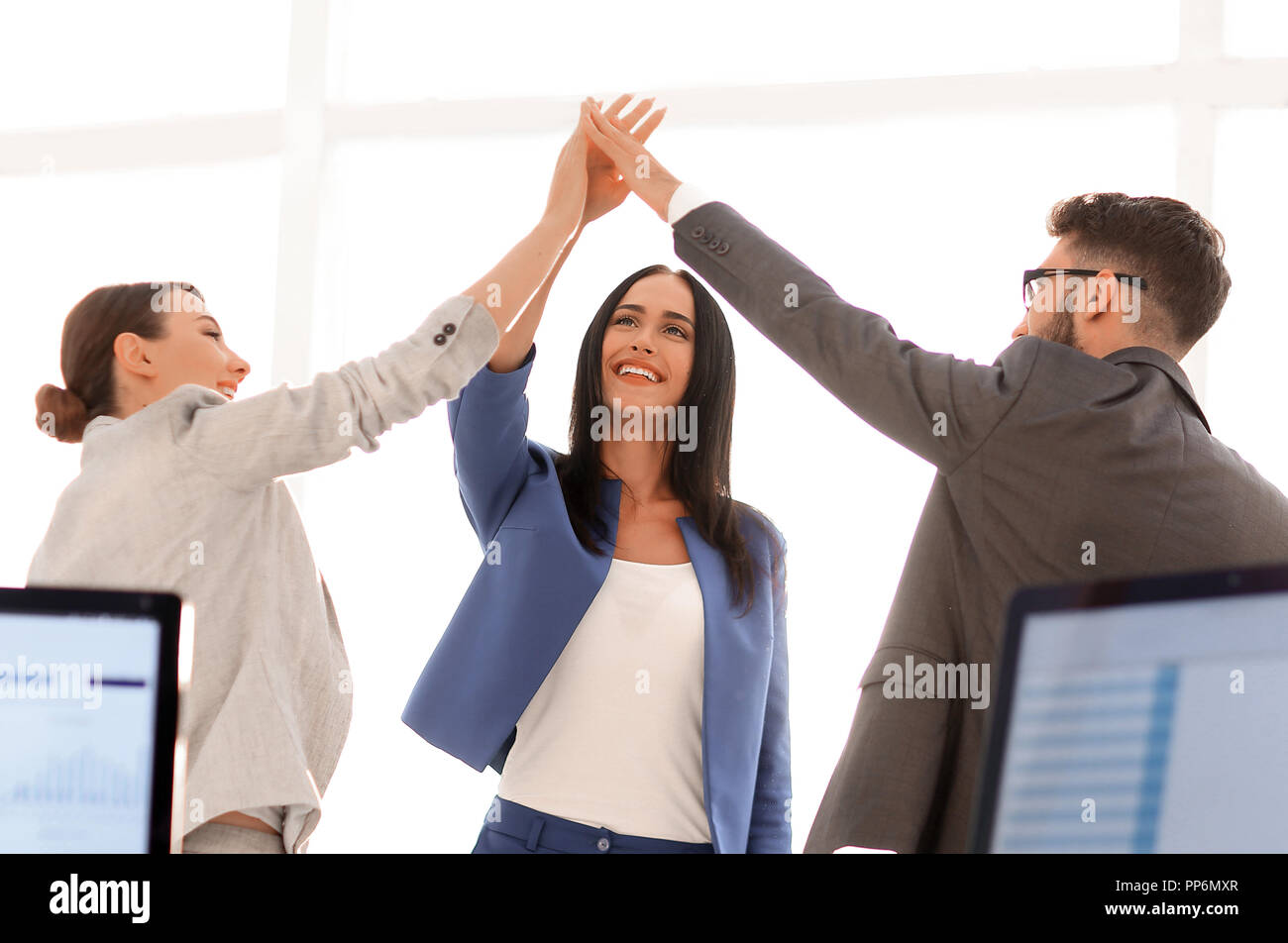 happy business team giving high five in office Stock Photo - Alamy