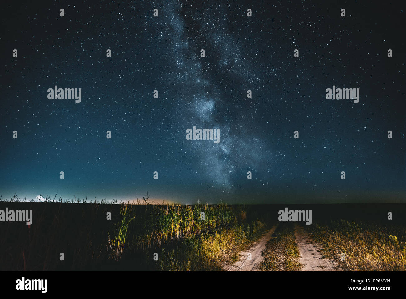 Night Starry Sky With Milky Way Glowing Stars Above Country Road In ...