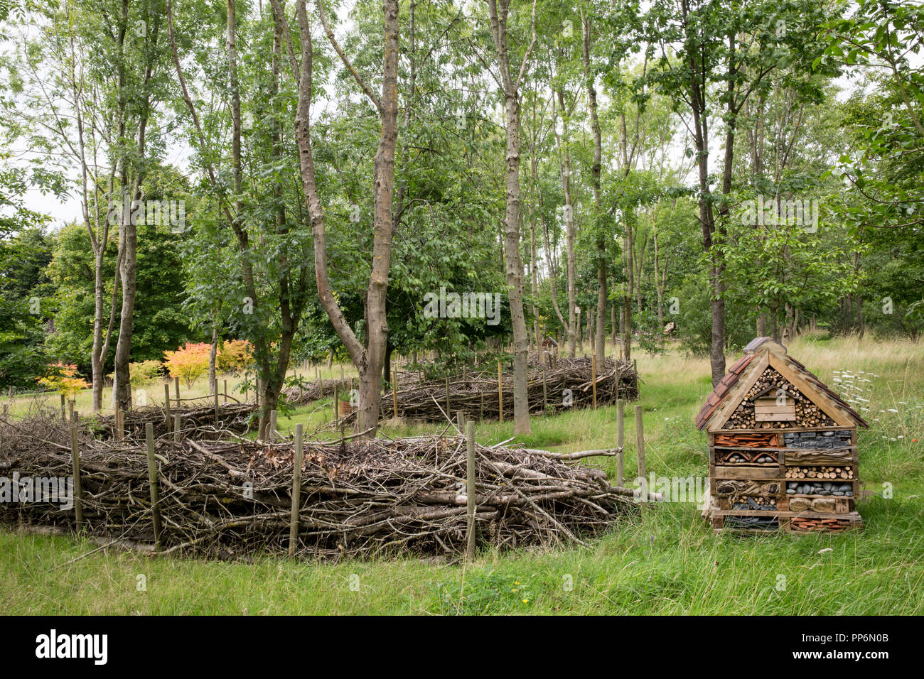 Garden with large bug house with several layers of different materials ...