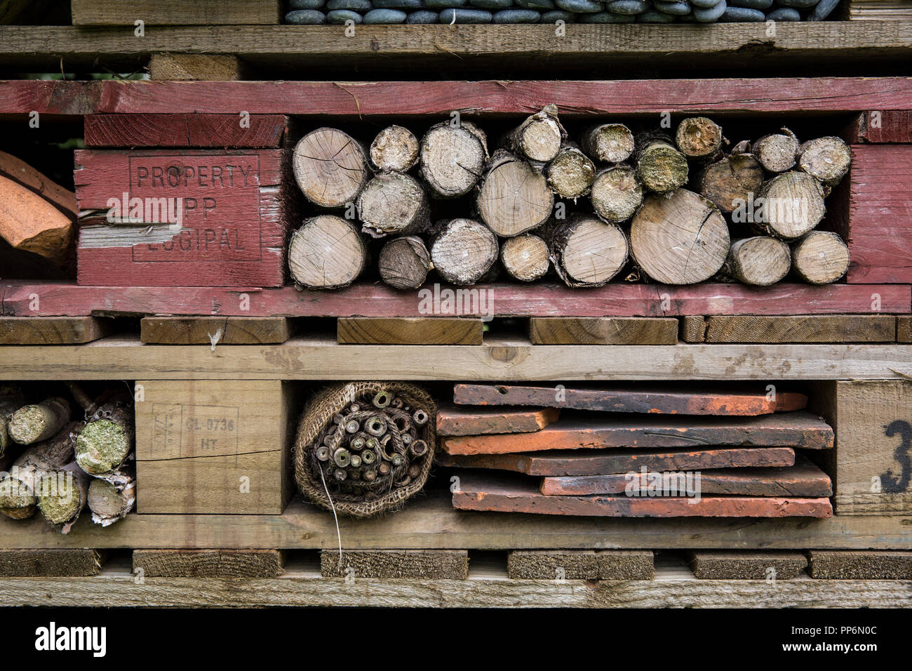 Close up of large bug house with several layers of different materials ...